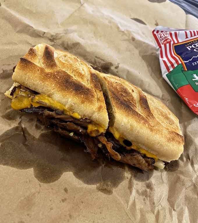 Crispy baguette, melted cheese, and smoky brisket peeking out, this sandwich is not playing around.
