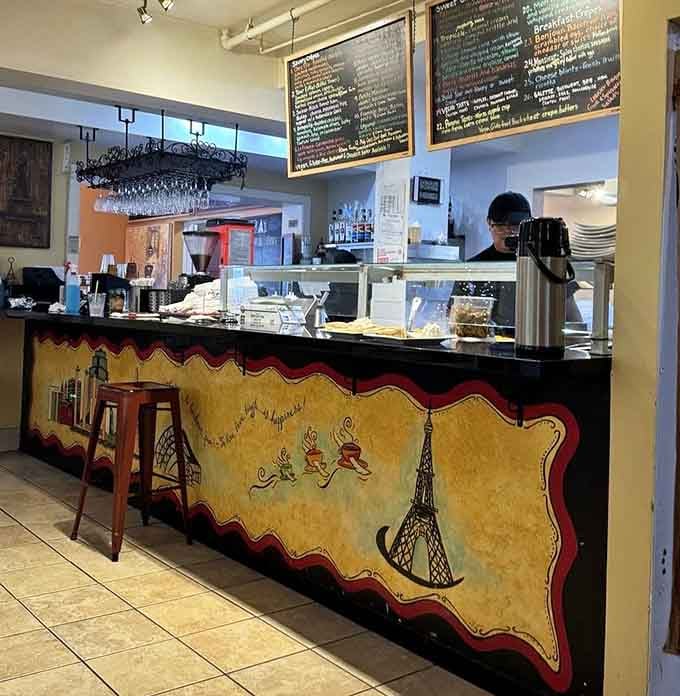 The service counter at Chez Elle features hand-painted Eiffel Tower artwork that quietly reminds you exactly where you are in spirit.