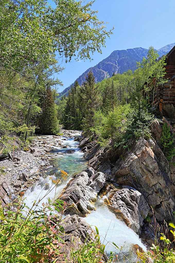 The Crystal River flows past rocks polished smooth by centuries of water doing its patient work.