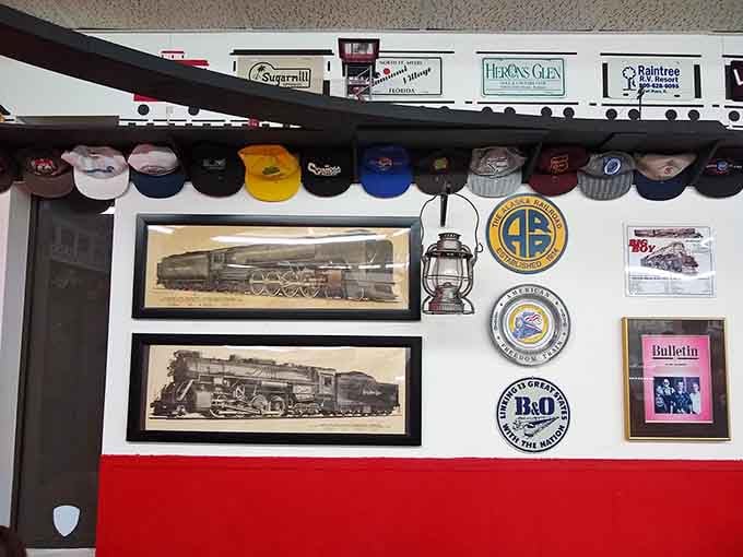 Framed locomotive prints, railroad medallions, vintage caps, and an old lantern &mdash; this wall tells a love story about trains.