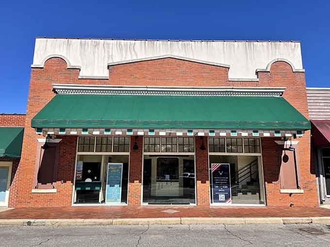 That green awning and brick facade on the Chautauqua Theatre building have seen more history than most Florida towns combined.