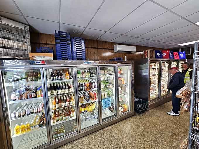 Cold beverages lined up like soldiers, standing at attention beside a freezer packed with proteins you didn't expect.