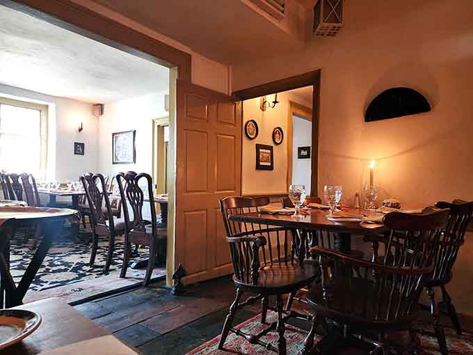 Wide-plank floors, candlelight, and Windsor chairs set for dinner. This room has been welcoming guests since before America had a name.
