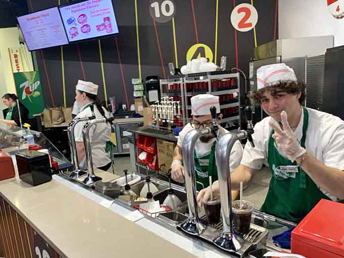 These cheerful soda jerks in their classic white caps are serving up cold drinks with the kind of enthusiasm money simply can't buy.