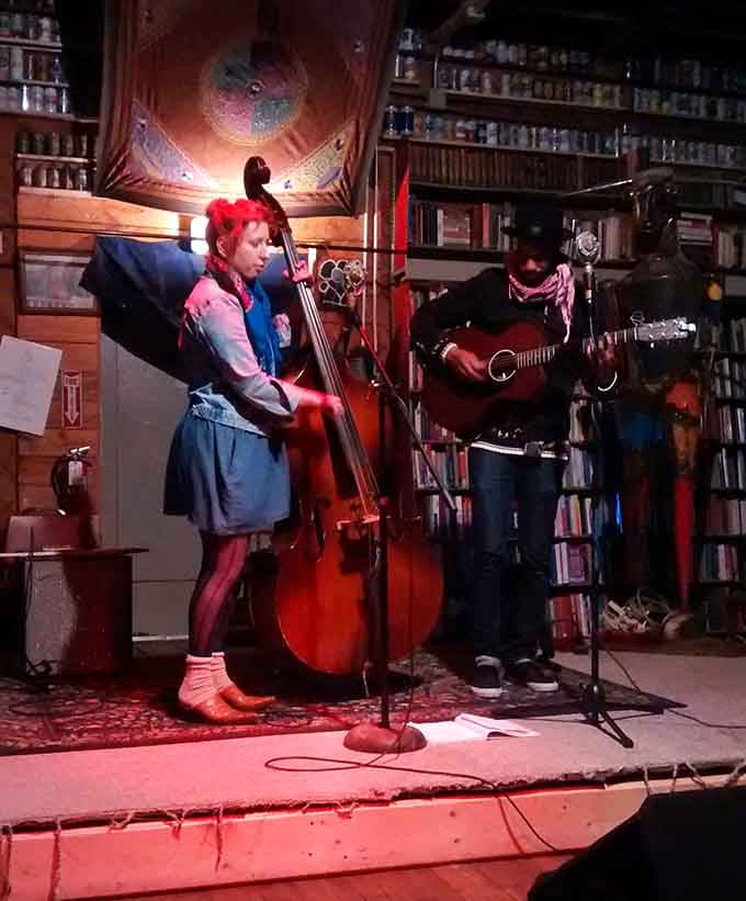 A double bass and an acoustic guitar performing surrounded by thousands of books, this is what culture looks like up close.