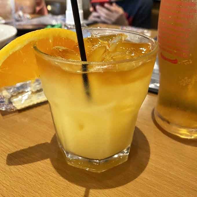 The Royal Flush cocktail looks like liquid sunshine decided to take a vacation in your glass.