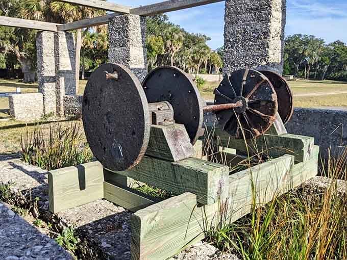 These rusted iron wheels sitting quietly beside tabby columns are the last word in industrial history.