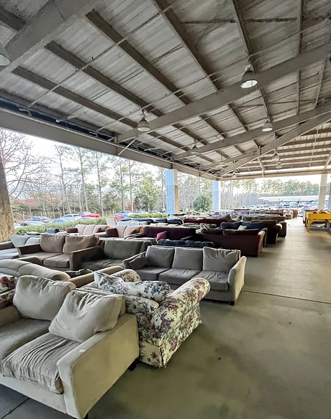 Sectionals, loveseats, and sofas lined up under a covered pavilion, this outdoor furniture display is bigger than most furniture showrooms.