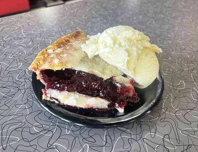 A thick slice of berry pie with a scoop of ice cream &mdash; Oregon on a plate, full stop.
