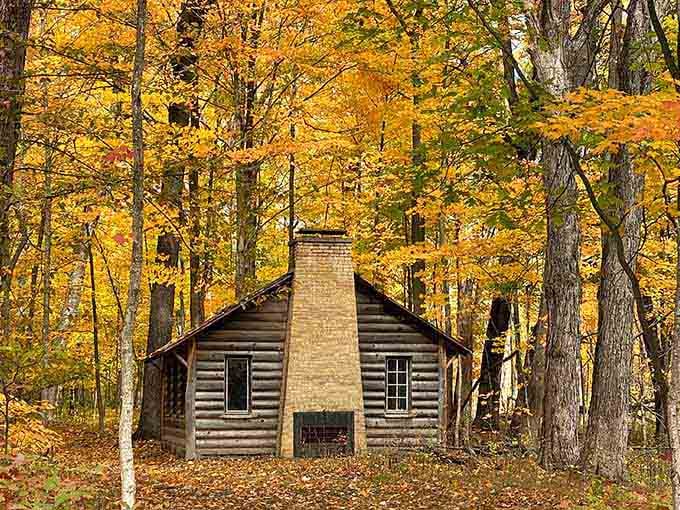 A historic cabin nestled in fall foliage looks like the cover of every calendar your grandmother ever owned.