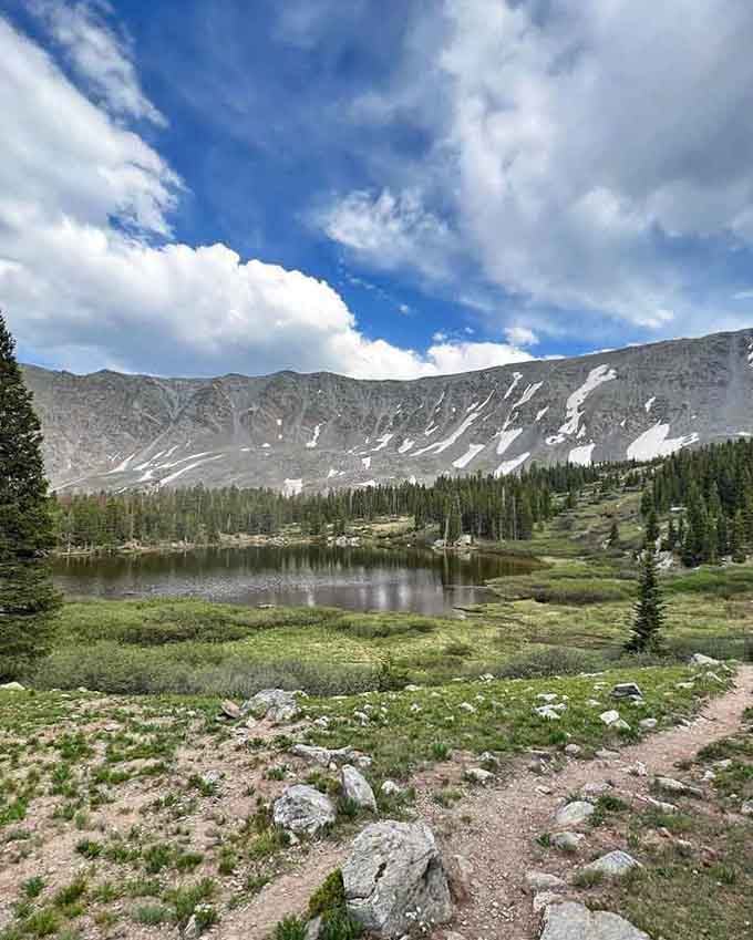 Alpine lakes reflect the surrounding peaks like nature's mirror, reminding you why people endure the thin air.
