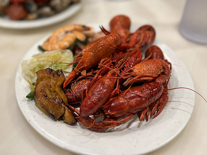 Crawfish piled on a plate like edible treasure, because some meals deserve a dramatic entrance.
