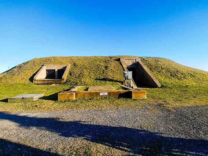 Grass grows over secrets here. Those bunker entrances carved into the hillside look like something straight out of a World War II film set.