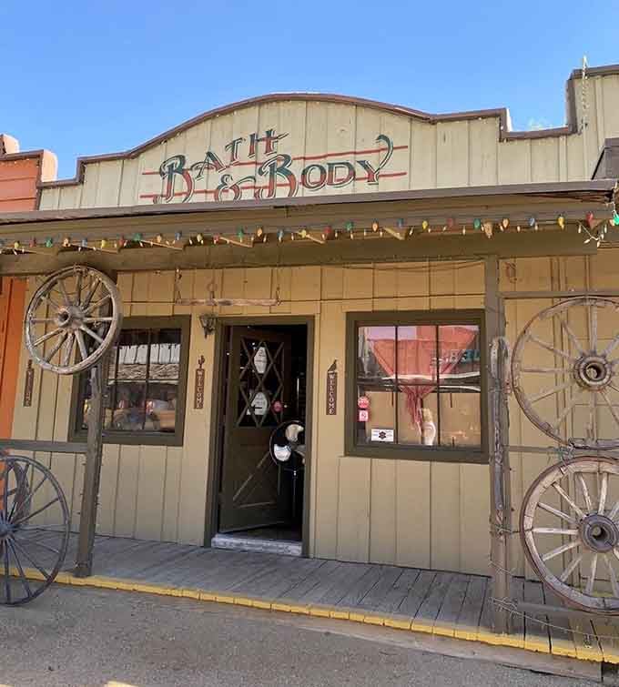 Wagon wheels flanking the doorway of a Bath and Body shop &mdash; the frontier never smelled this good.