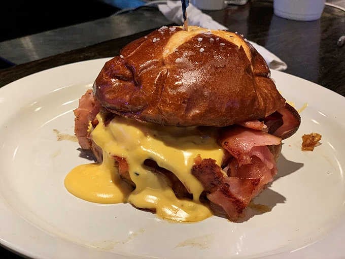 The Drunken Pig on a pretzel bun, drowning in cheese sauce, is the most beautiful mess you'll ever eat.