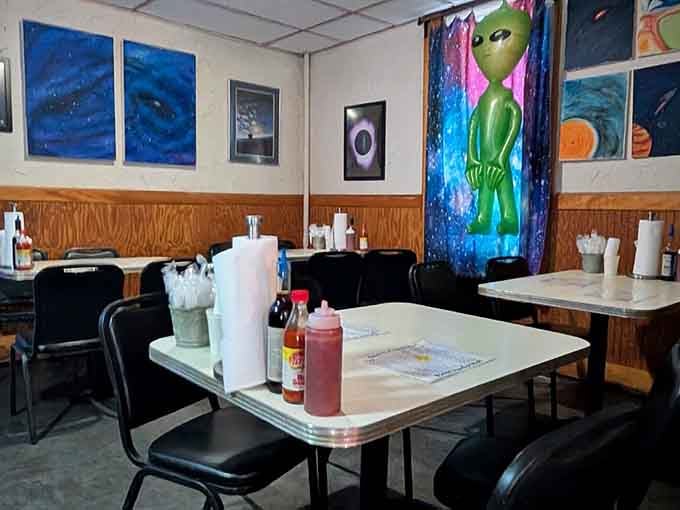 Space-themed posters and vintage sci-fi vibes create an atmosphere that's equal parts nostalgic diner and intergalactic adventure.