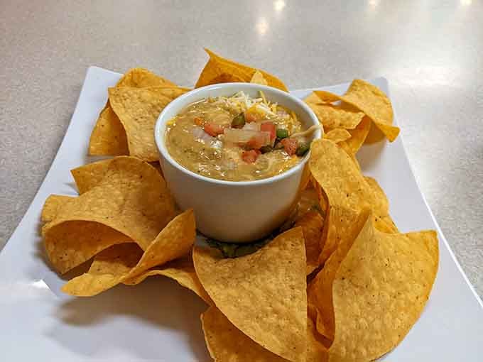 Chips and queso done right, warm, loaded with toppings, and clearly not interested in being ordinary.