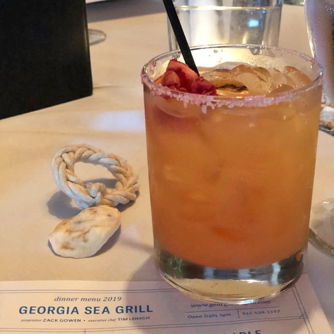 That rosy, salt-rimmed cocktail sitting next to a little rope knot is basically St. Simons Island in a glass.