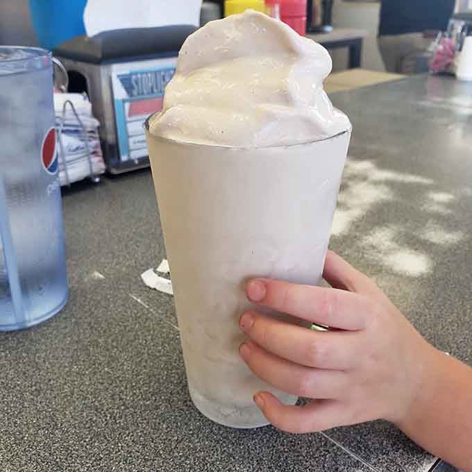 That milkshake isn't just a drink, it's a full-on event served in a frosty glass with a smile.