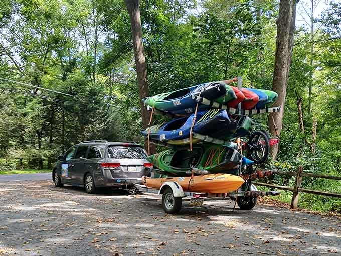 A rainbow of kayaks stacked high means someone's about to have the kind of day worth remembering and repeating.