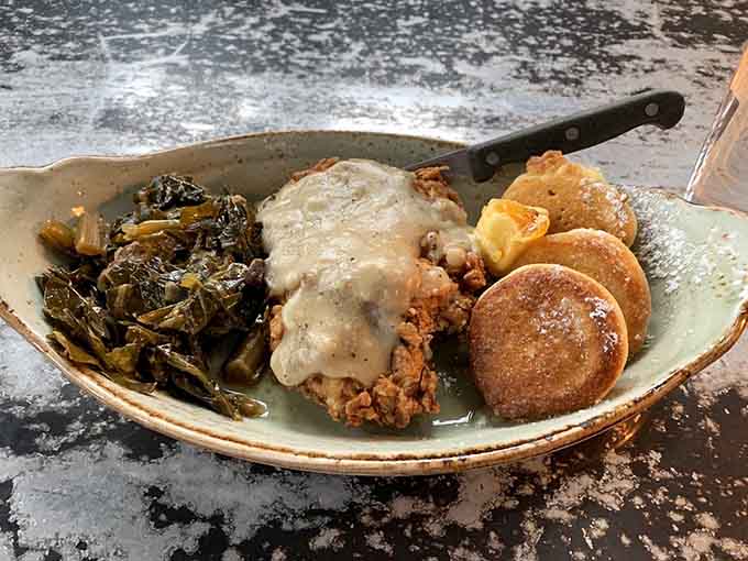 Skillet fried chicken with collard greens, hoecakes, and sawmill gravy, Southern comfort food that means serious business.
