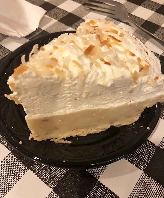 Coconut cream pie piled high with toasted coconut and whipped cream, the dessert equivalent of a standing ovation.