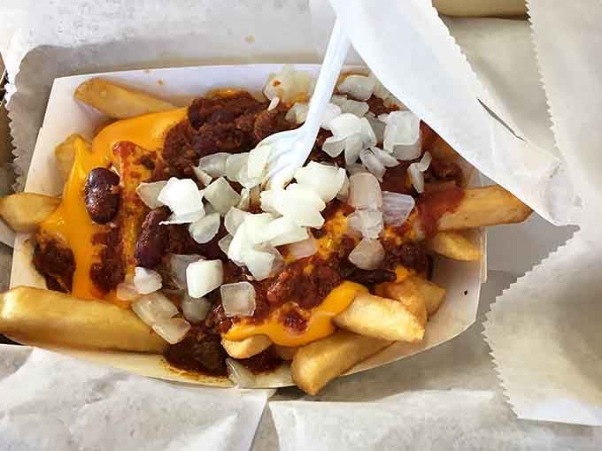 Chili cheese fries topped with onions: comfort food that doesn't apologize for being exactly what you need.