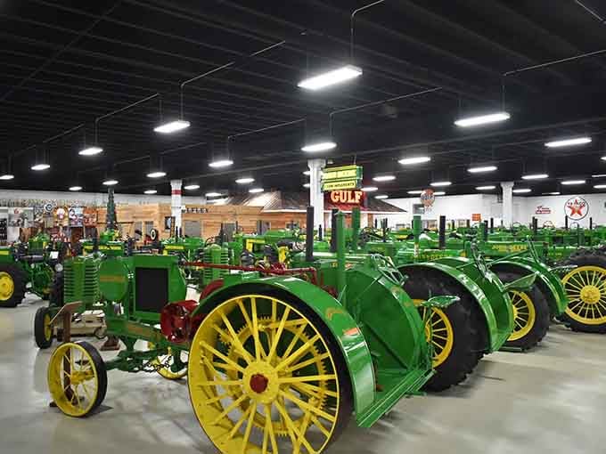 A whole congregation of John Deere tractors lined up like they're waiting for something important to happen.