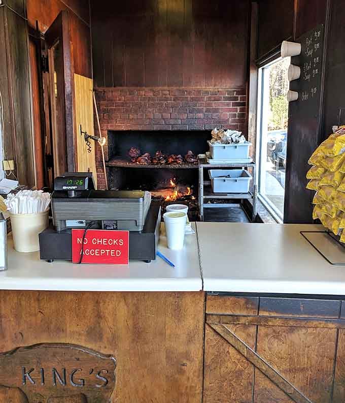 An open-fire pit doing real work behind the counter. This is where the magic actually happens, no smoke and mirrors required.