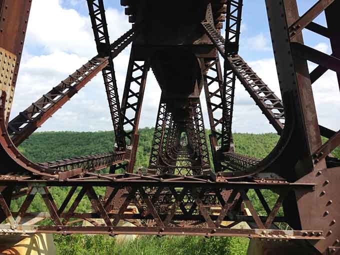 The intricate lattice of steel beams and rivets showcases craftsmanship from an era when they built things to last forever.