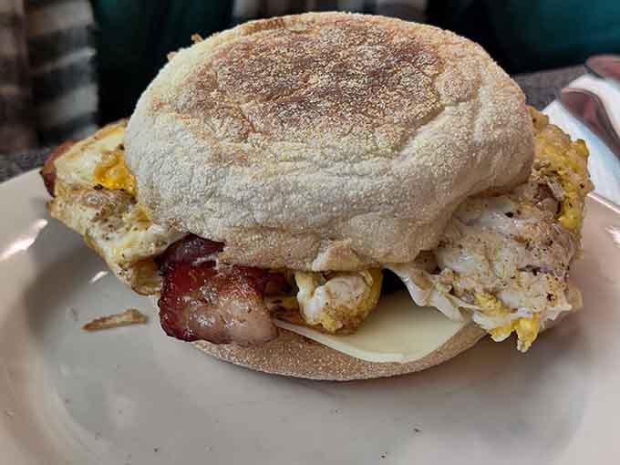 The McKuppy's Sandwich stacked high on a toasted English muffin. Bacon, egg, and cheese never looked so serious.