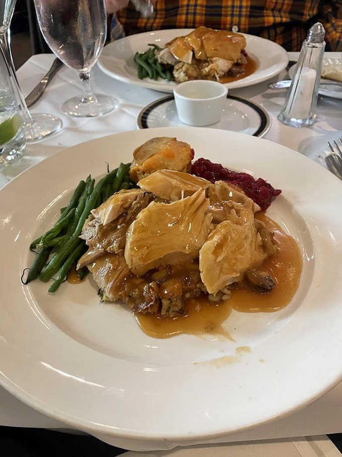 A generous turkey dinner with green beans and cranberry sauce. La Ferme makes even the classics feel like a special occasion.