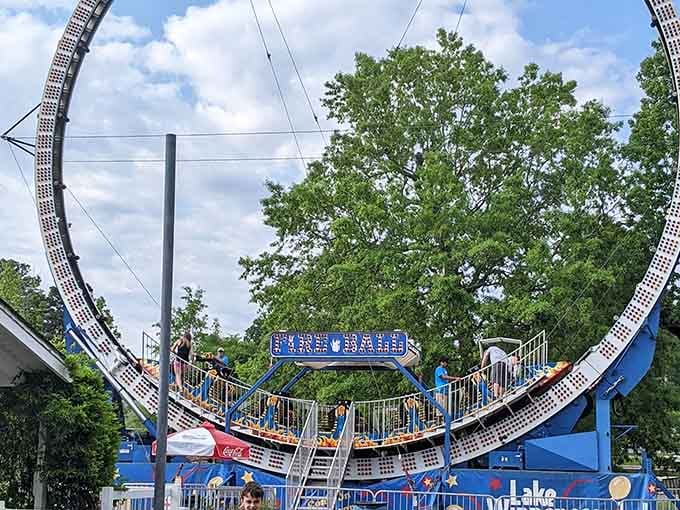 The Fireball ride loops against a perfect summer sky, and somewhere in line, someone is quietly reconsidering their life choices.