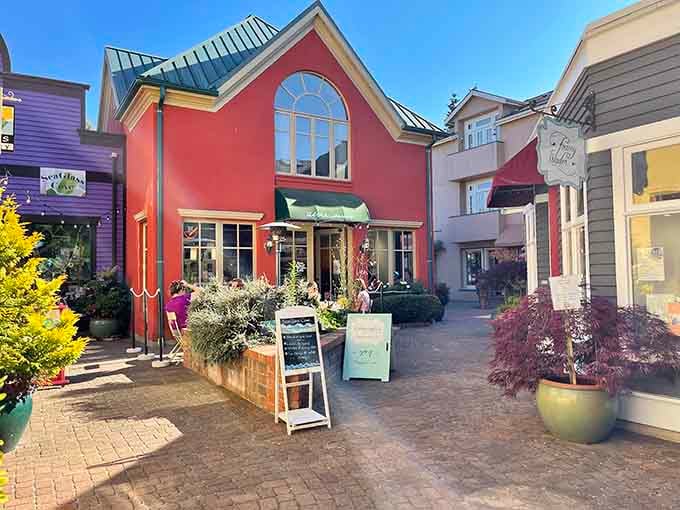 Tucked behind lush greenery, this vibrant red building houses one of Langley's most delightful dining courtyards.