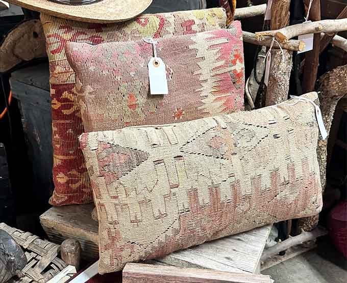 Vintage textile pillows with rich, faded patterns that look like they've already lived a very interesting life somewhere wonderful.
