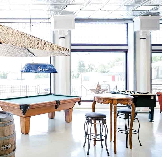 A pool table, foosball, and wooden barrels. The game room here doesn't mess around, not even a little.
