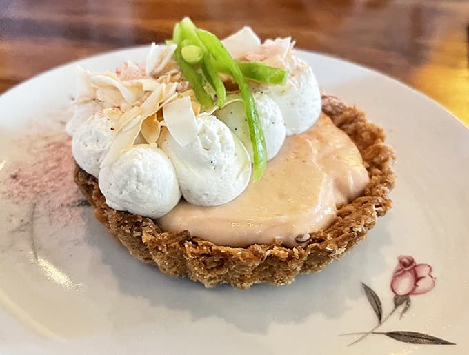 This tart topped with meringue clouds proves that pastry chefs are basically edible architects with better job satisfaction.