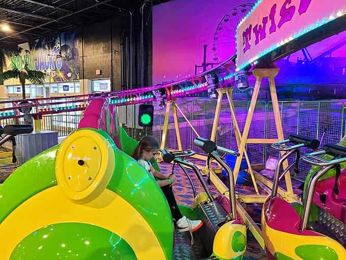 Neon pink lights, a Twist-N-Shout coaster sign, and one very focused little rider equal one unforgettable afternoon.