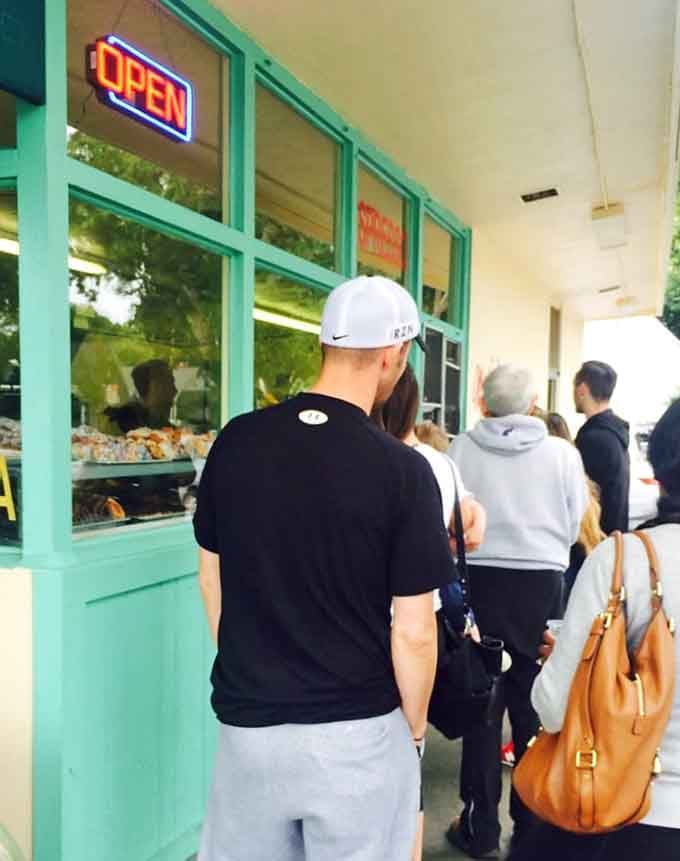 The line outside tells the whole story: when donuts are this good, people happily wait for their turn.