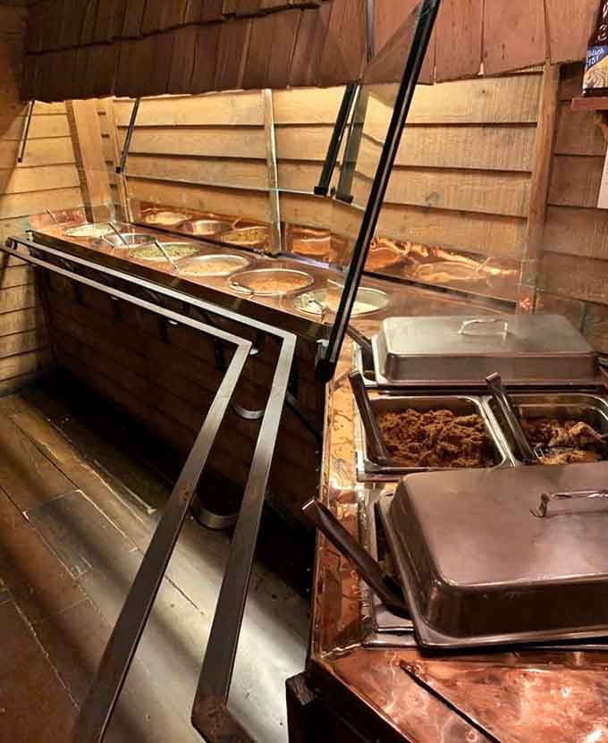 The buffet line beckons with steaming trays of Southern comfort, all you can eat colonial-style.