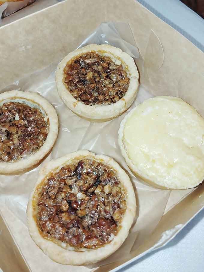 Four small pies in one box, three pecan and one custard, a genuinely excellent life decision.