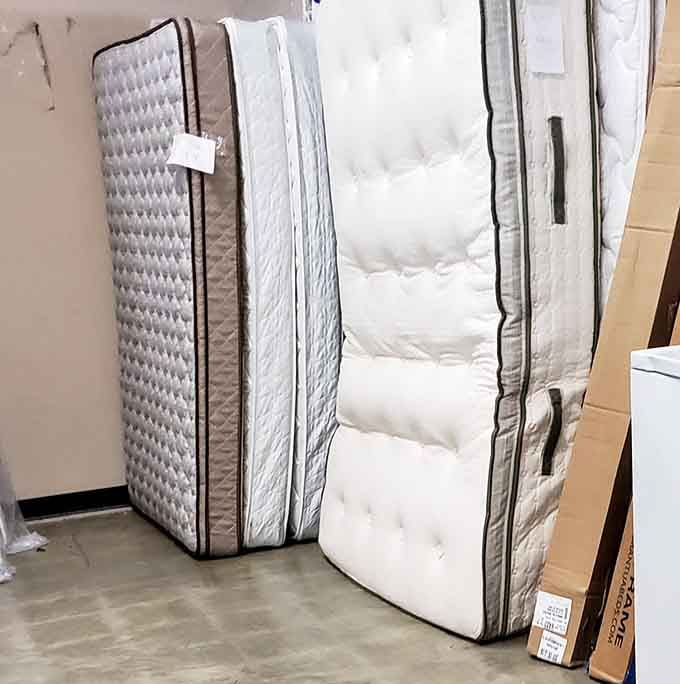 Mattresses standing at attention like soldiers, ready to give someone a genuinely good night's sleep on a budget.