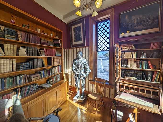 A suit of armor standing guard over shelves of old books, because every castle needs its own silent librarian.