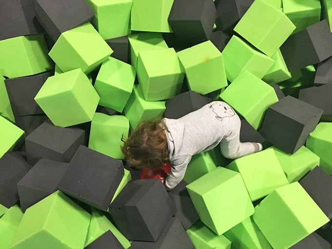 Buried in foam blocks, this is what victory looks like when you successfully launch yourself into the pit below.