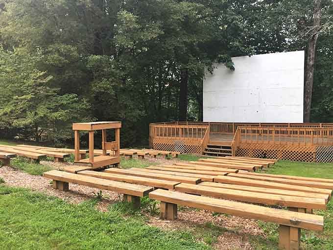 An outdoor amphitheater tucked into the woods. Nature provides the opening act, every single time.