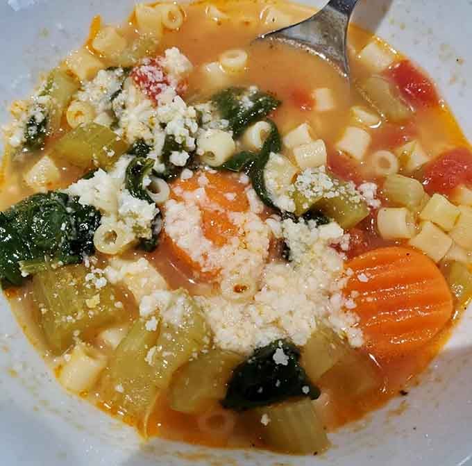 A bowl of minestrone this loaded, with pasta, carrots, spinach, and a generous snowfall of grated cheese, is pure comfort.