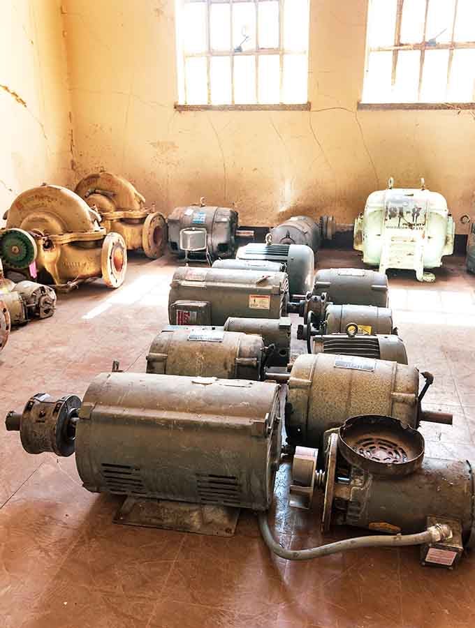 Rows of old industrial motors sit forgotten on the floor, still lined up like soldiers waiting for orders that never came.