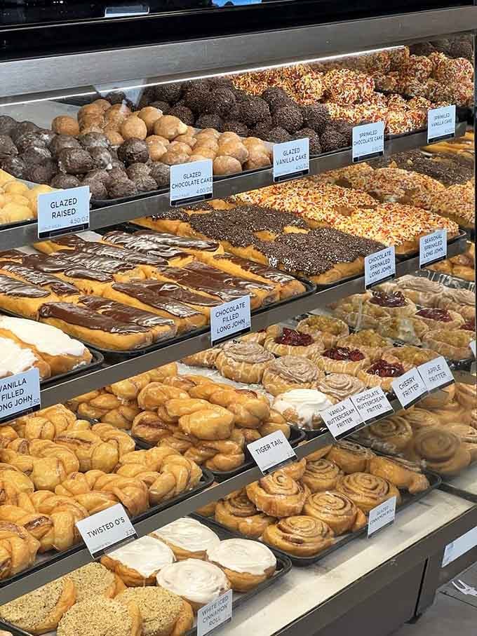 Glazed raised, Tiger Tails, cinnamon rolls, and fritters lined up like the world's most delicious police lineup.