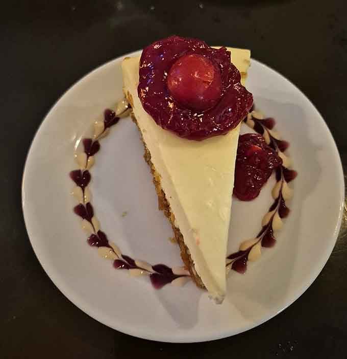 Creamy cheesecake topped with glossy cherry compote and ringed with berry drizzle hearts, dessert that's almost too pretty to eat.