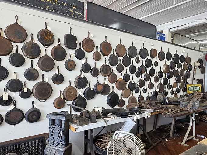 Dozens of cast iron skillets hanging like medals of honor, each one earned through decades of good cooking.